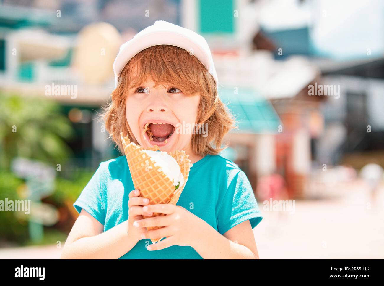 Cute kid eating licking big ice cream in waffles cone happy laughing on ...