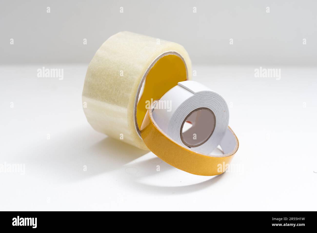 Roll of adhesive tape isolated on white Stock Photo - Alamy
