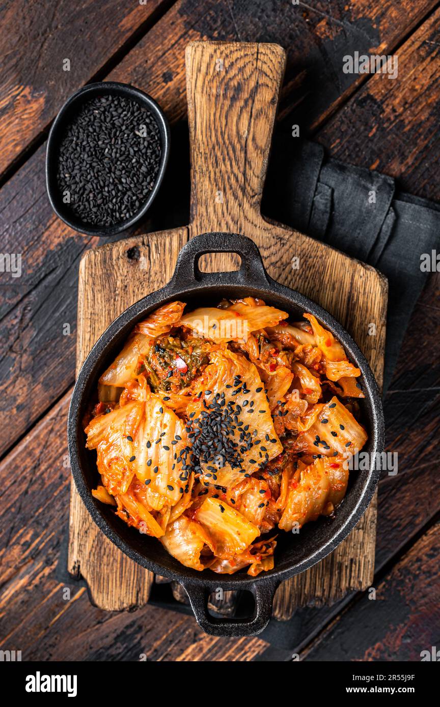 Kimchi salted and fermented chinese cabbage in a skillet. Wooden ...