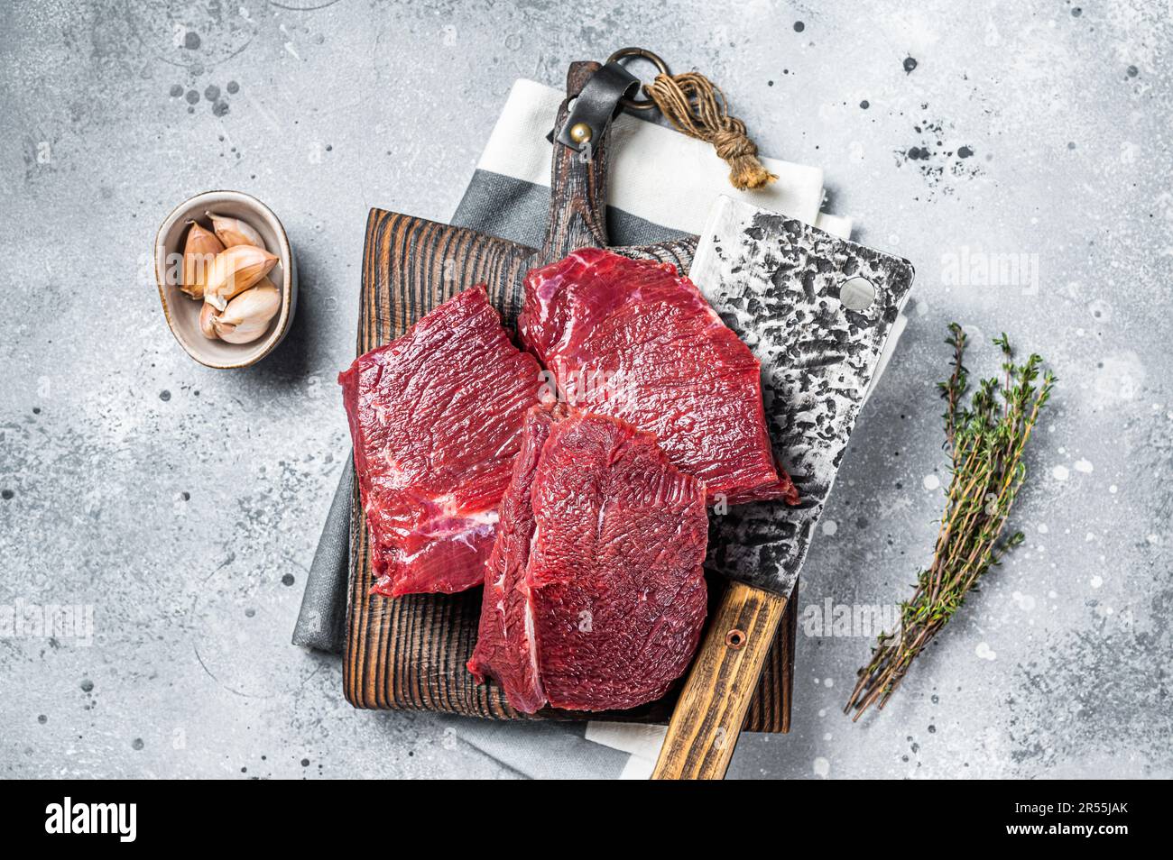 Raw Venison dear meat on butcher cutting board, game meat. Gray ...