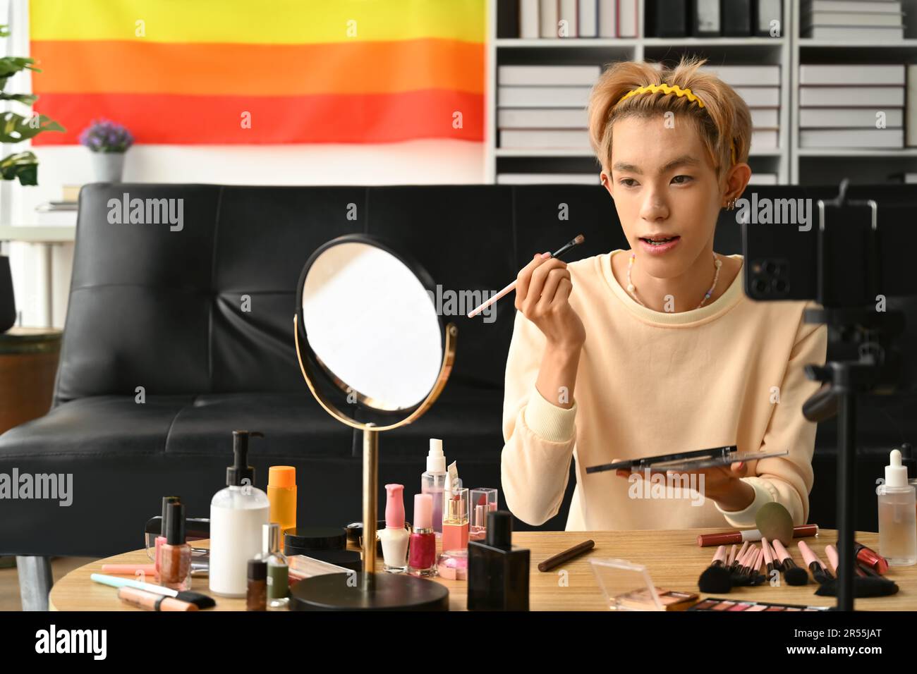 Portrait of transgender male beauty blogger recording makeup tutorial ...