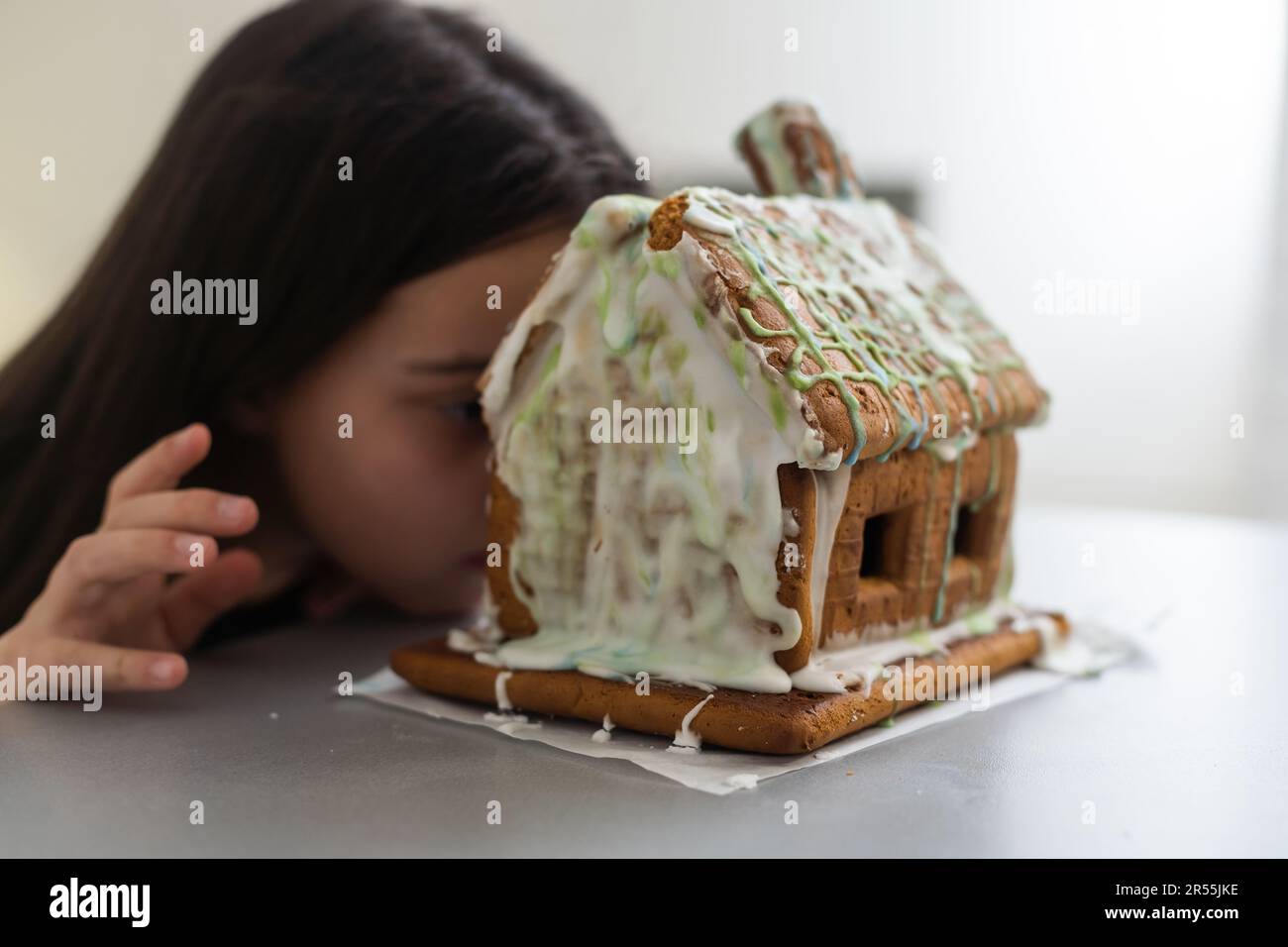 Kids with gingerbread house, A teenage girl is eating a gingerbread ...