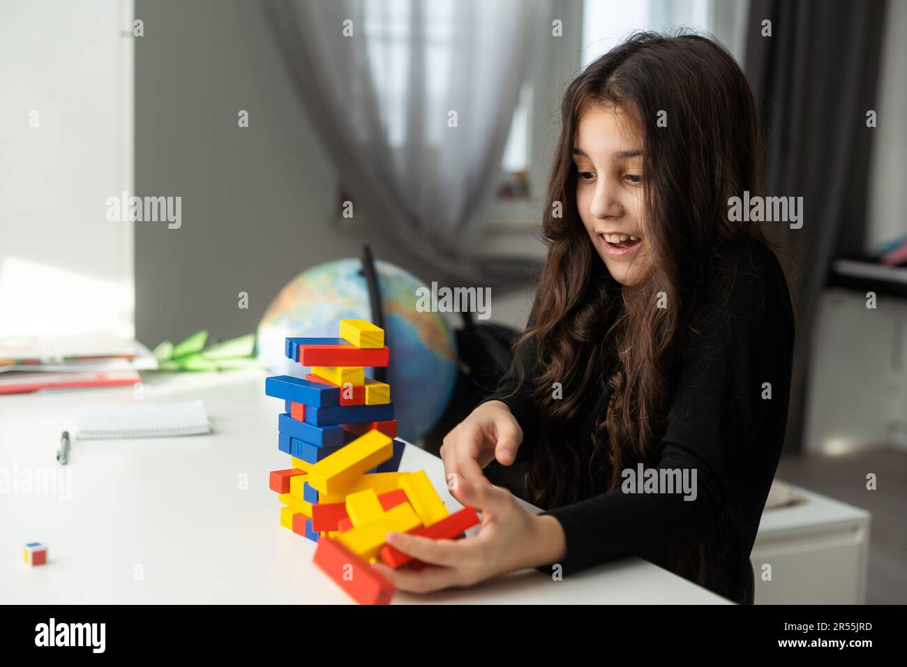 Children building wood blocks at playground. Girl kid playing stacking ...