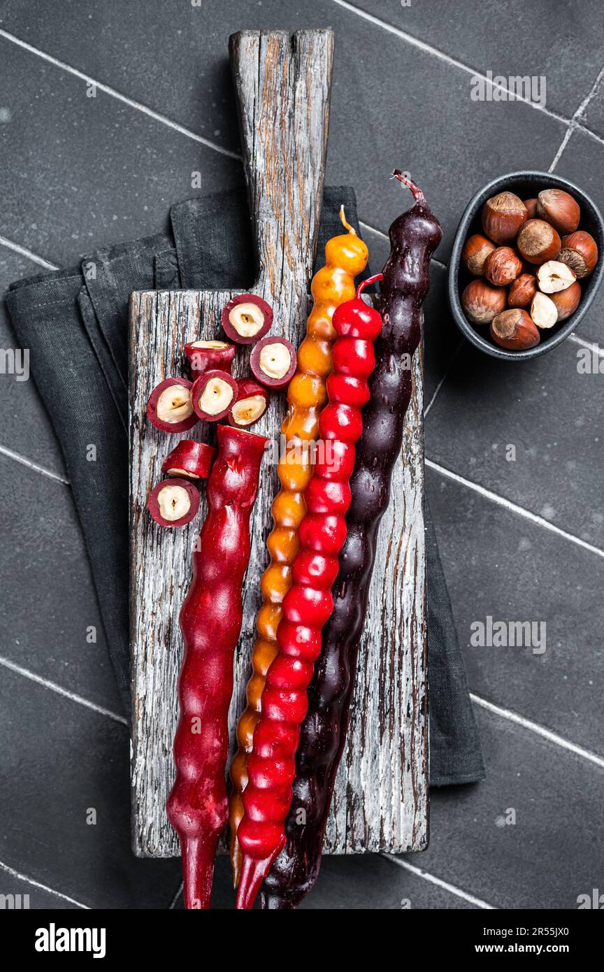 Georgian sweets Churchkhela with sap and hazelnuts. Black background ...