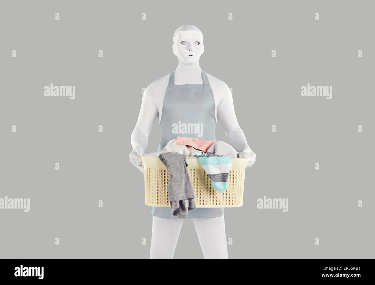 Robot or man in white bodysuit, mask and apron helping with housework ...