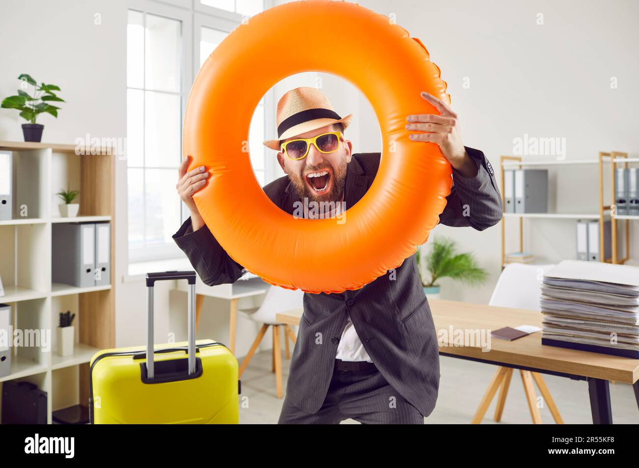 Happy funny business man with inflatable beach ring is excited about ...