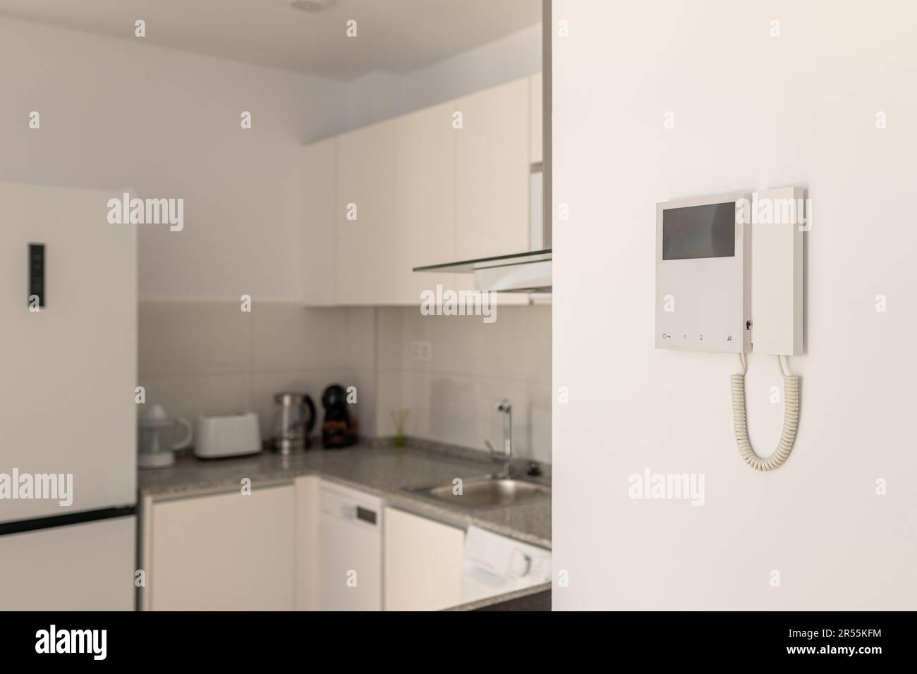 Blurred Ivory color kitchen island set next to refrigerator and ...