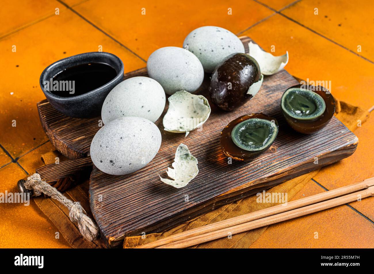 Chinese Century egg, preserved duck eggs. Orange background. Top view ...