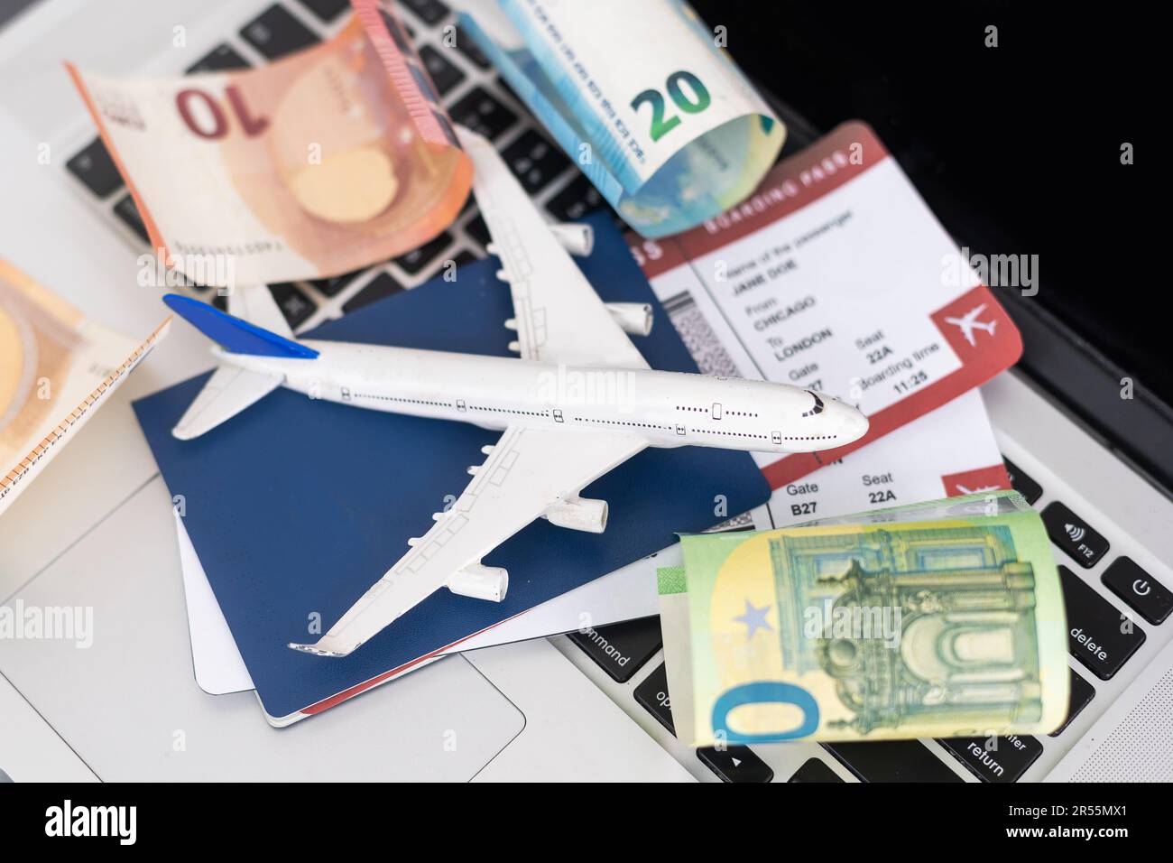 Composition with laptop, toy plane, money and passport on map. Travel ...