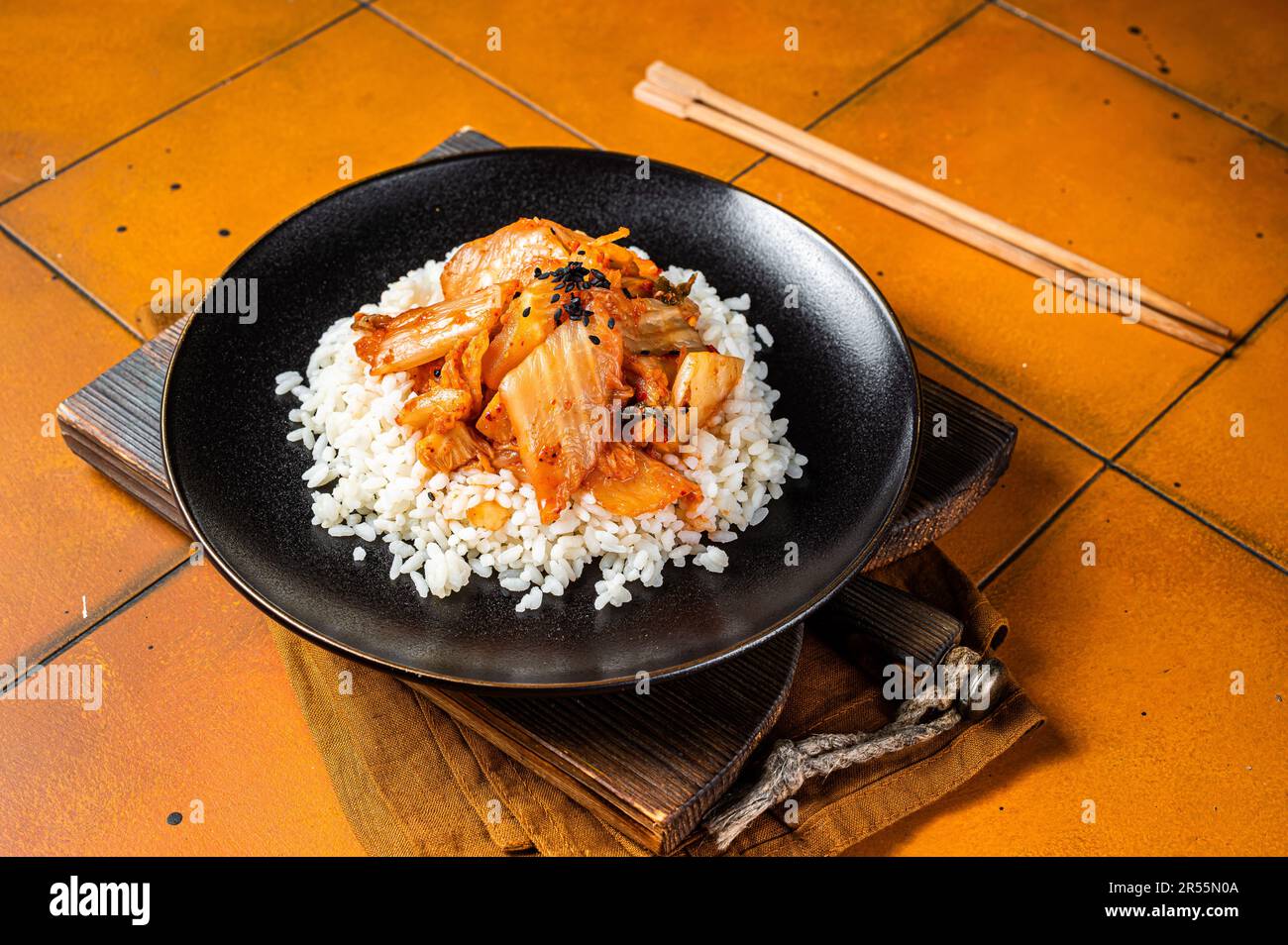 Kimchi with pork on cooked rice, traditional Korean cuisine. Orange ...