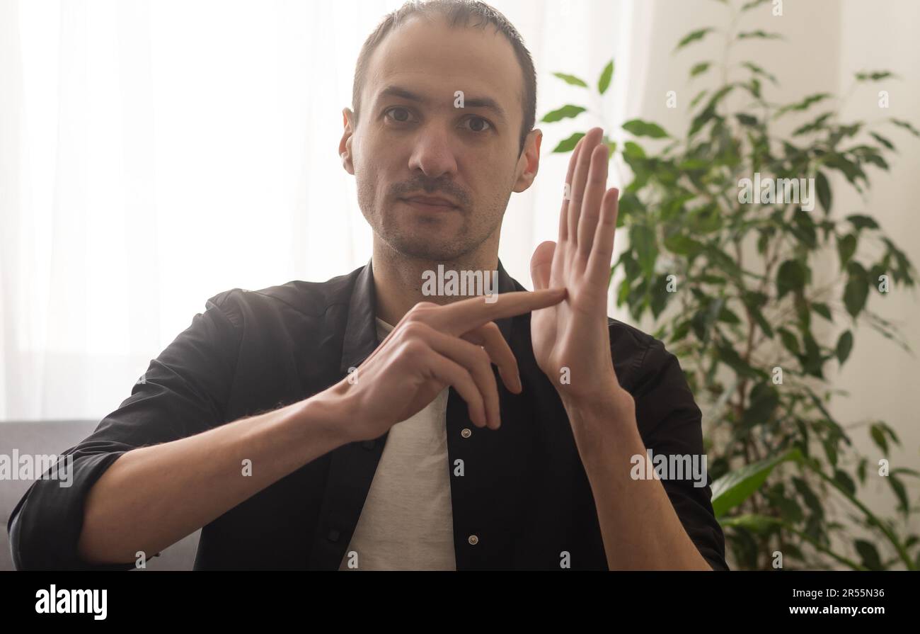 Adult Learning Sign Language For Deaf Disabled Stock Photo - Alamy