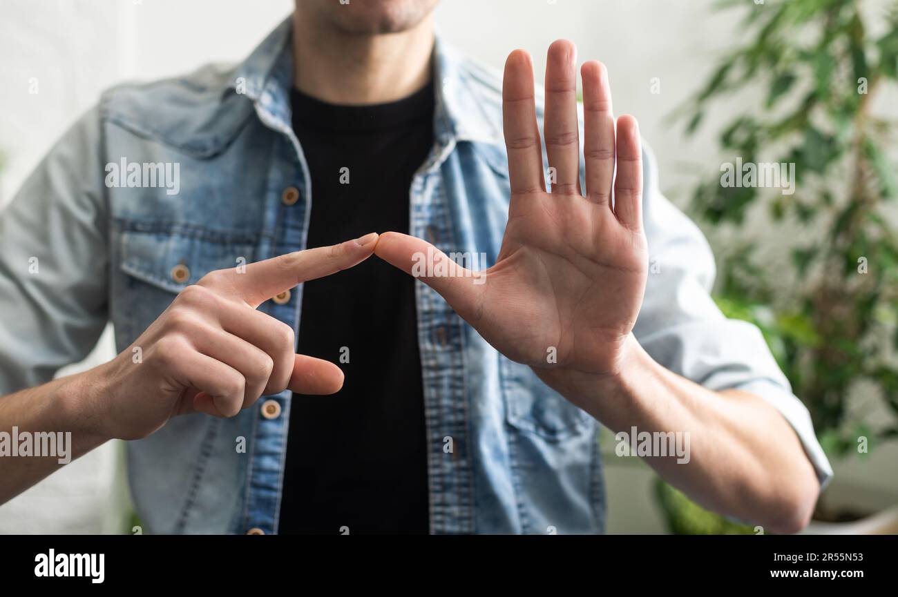 Adult Learning Sign Language For Deaf Disabled Stock Photo - Alamy
