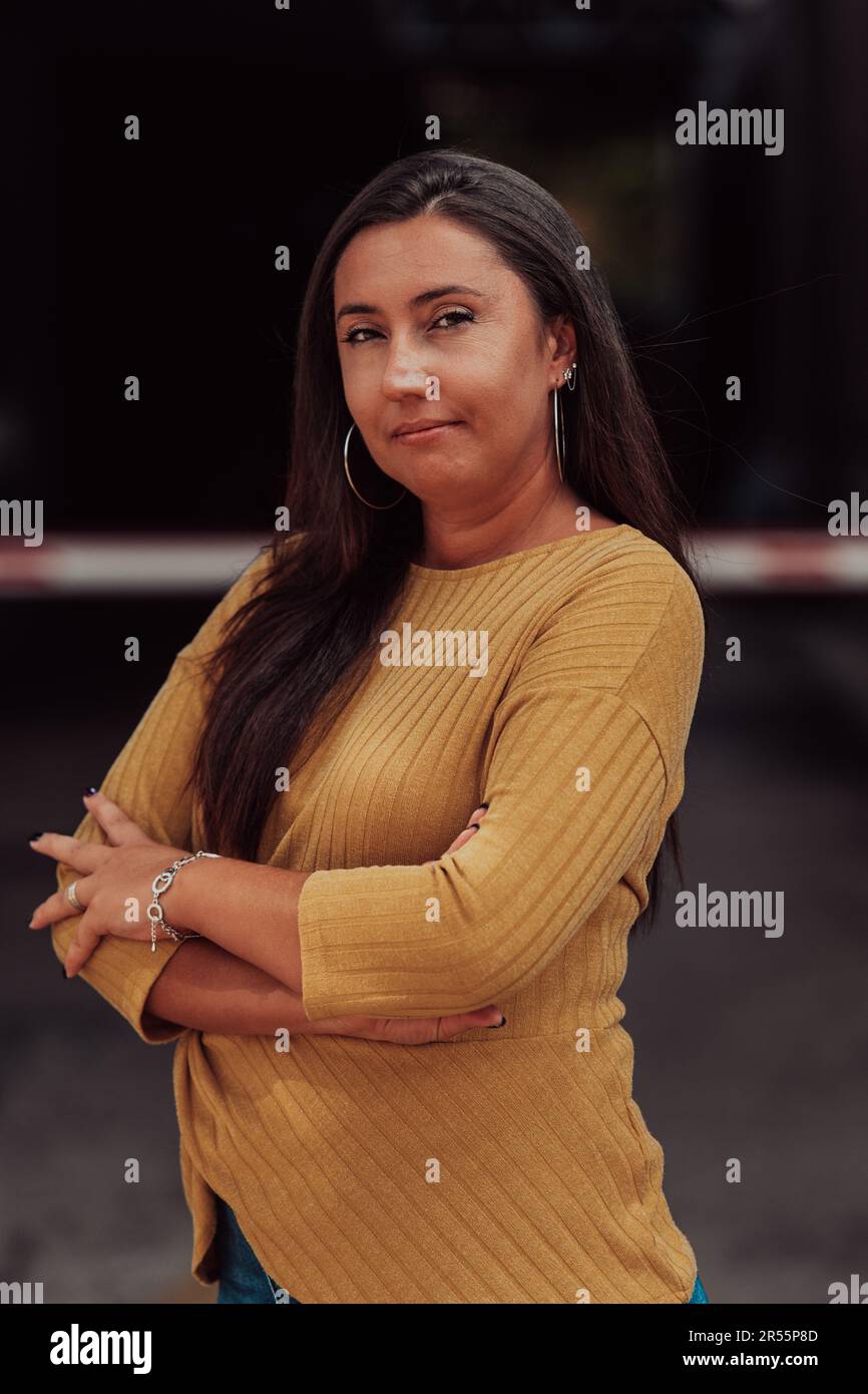 A powerful portrait of a businesswoman, standing confidently with her ...