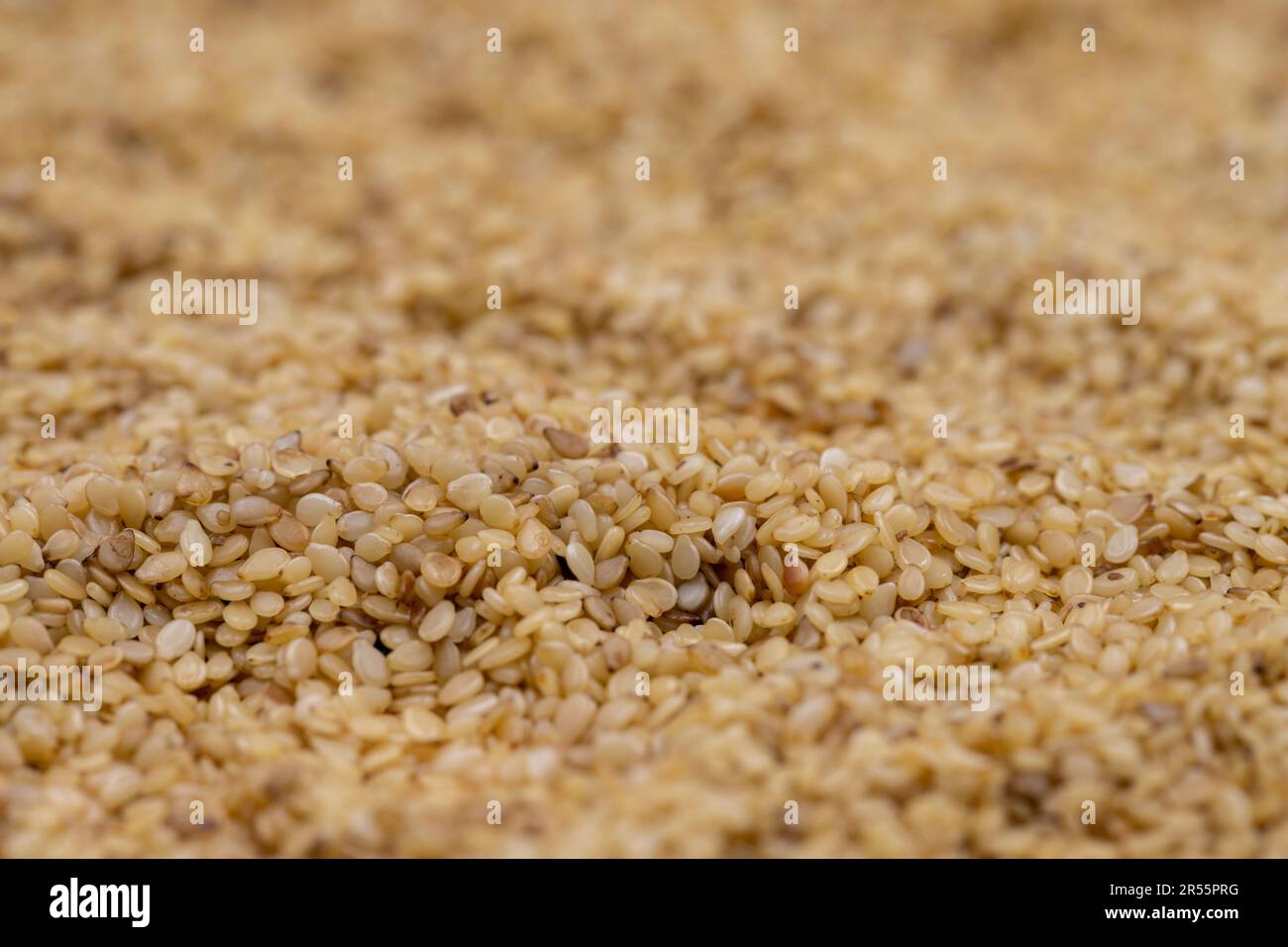 Pile of sesame seeds as background, spice or seasoning as background ...