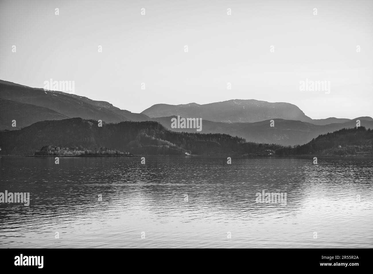 Fjord with view of mountains and fjord landscape in Norway in black and ...