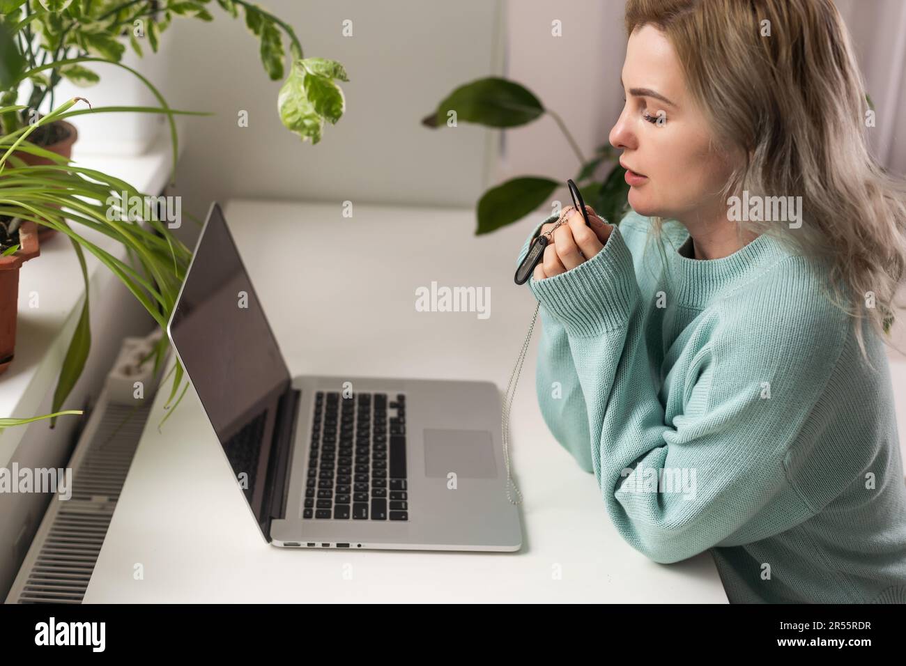 woman holding in hand military token Stock Photo - Alamy