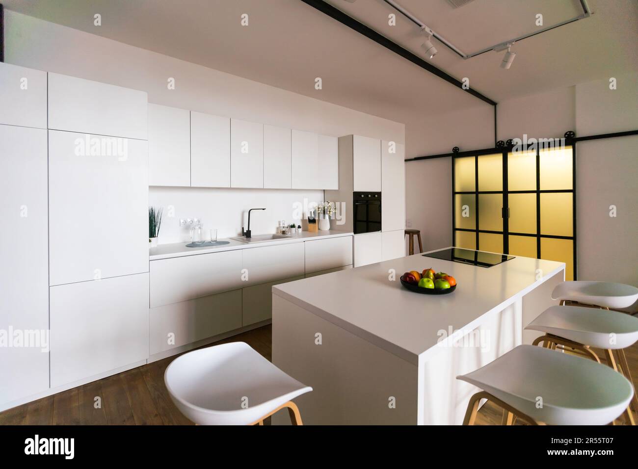 Gourmet kitchen features white shaker cabinets with marble countertops ...