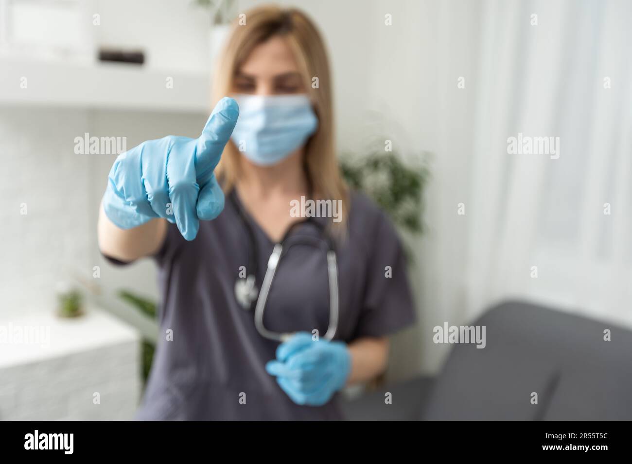 female doctor's hands in nitrile blue gloves show finger Stock Photo ...