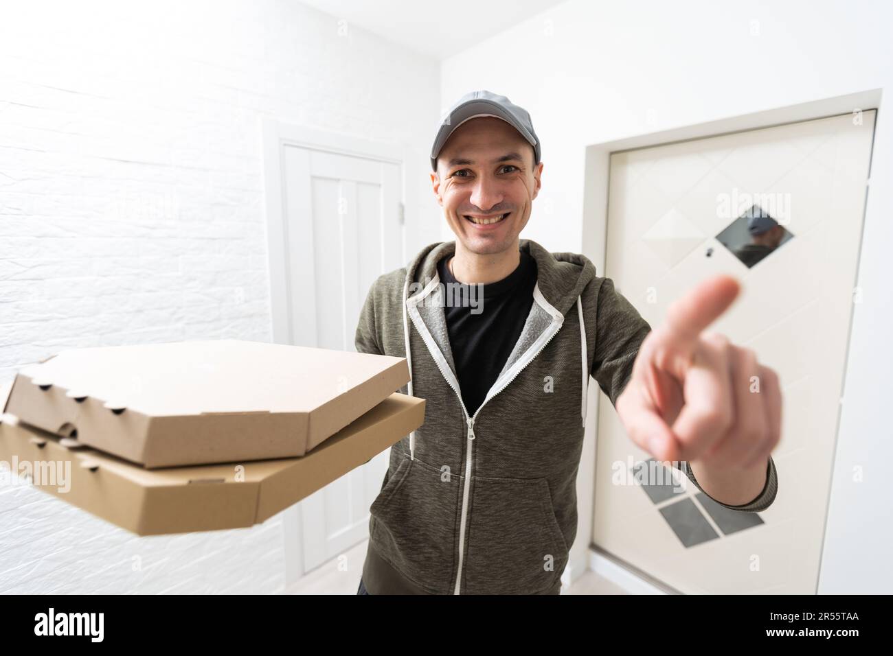 Delivery man delivering food order, fruit in a cardboard box, seen ...
