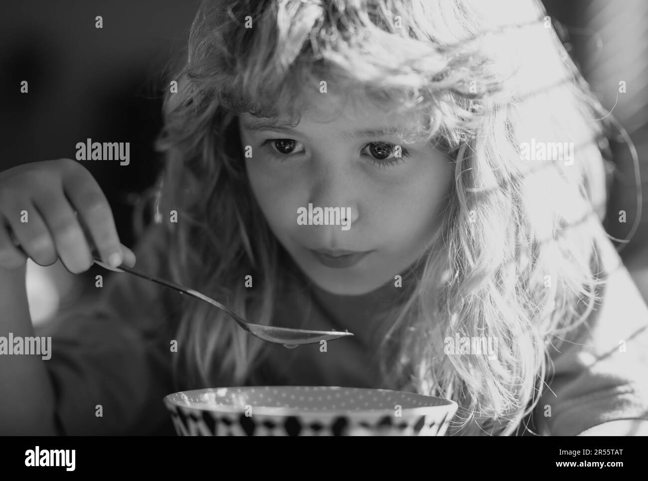 Child eating on blurred background. Hungry little boy eating. Adorable ...