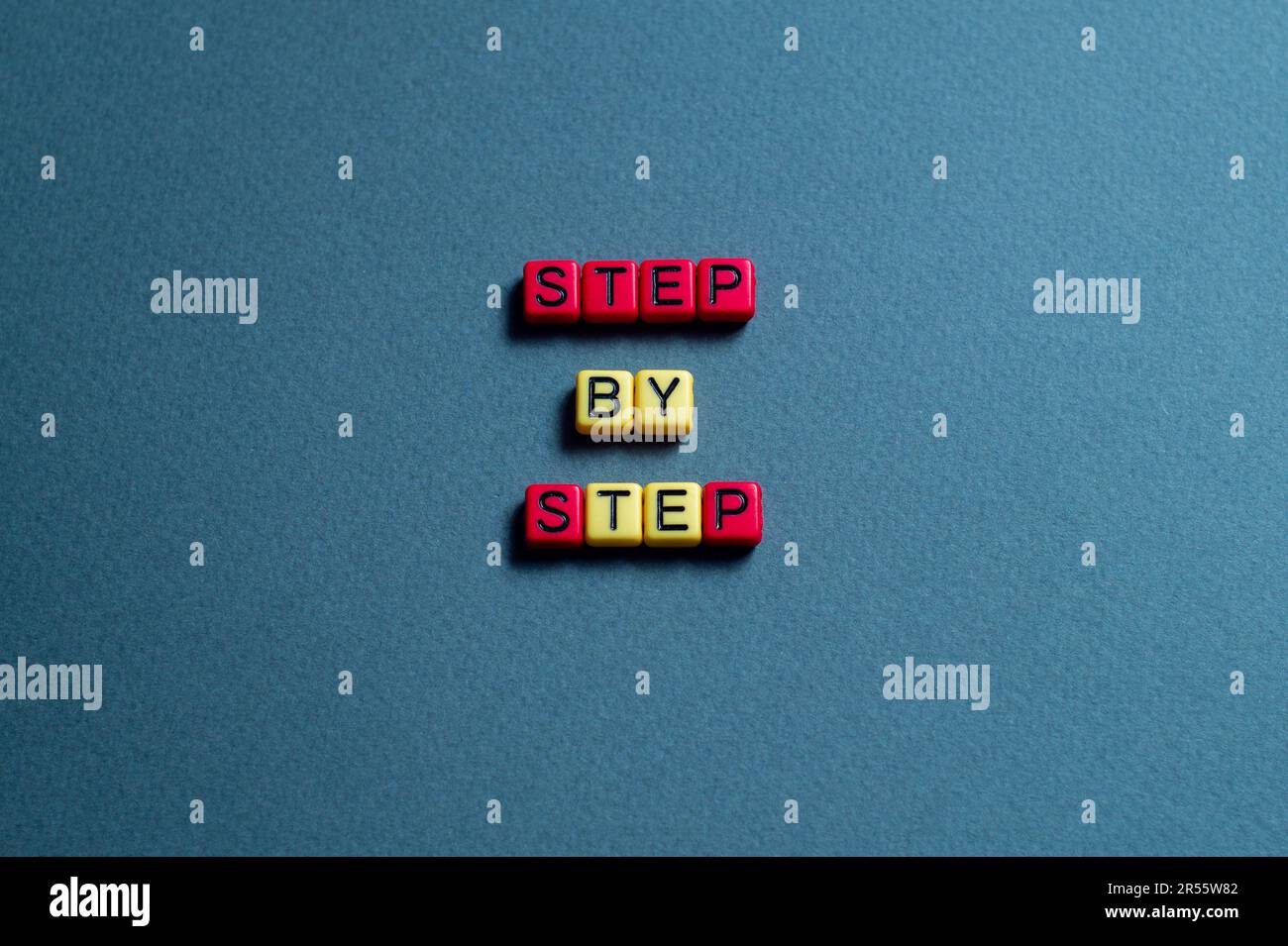 Step by step - word concept on cubes, text Stock Photo - Alamy