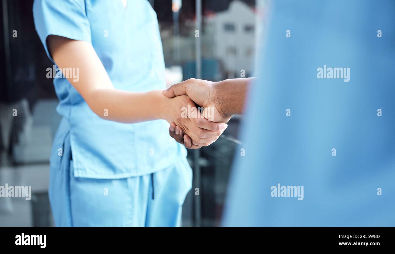 Hand, doctor and nurse handshake in hospital for medical, healthcare or ...
