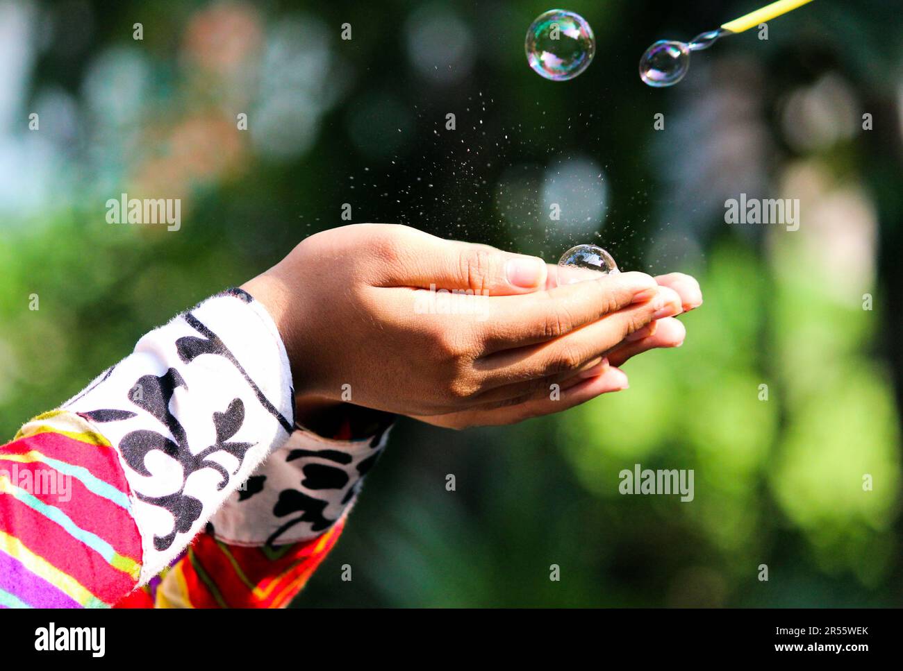 Girl touching soap bubble with beautiful hands Stock Photo - Alamy