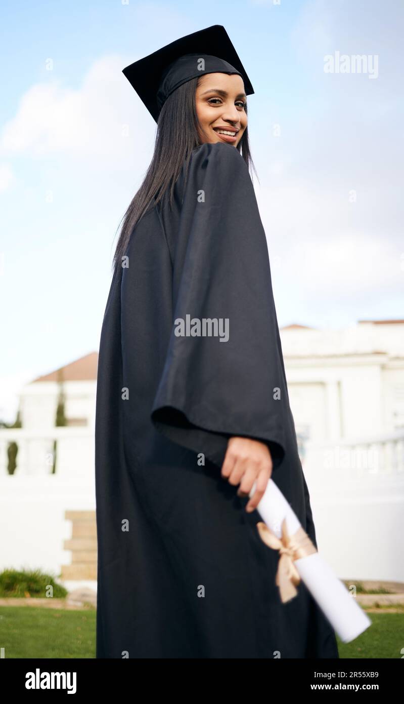 Portrait, education and back with a woman graduate on university campus ...