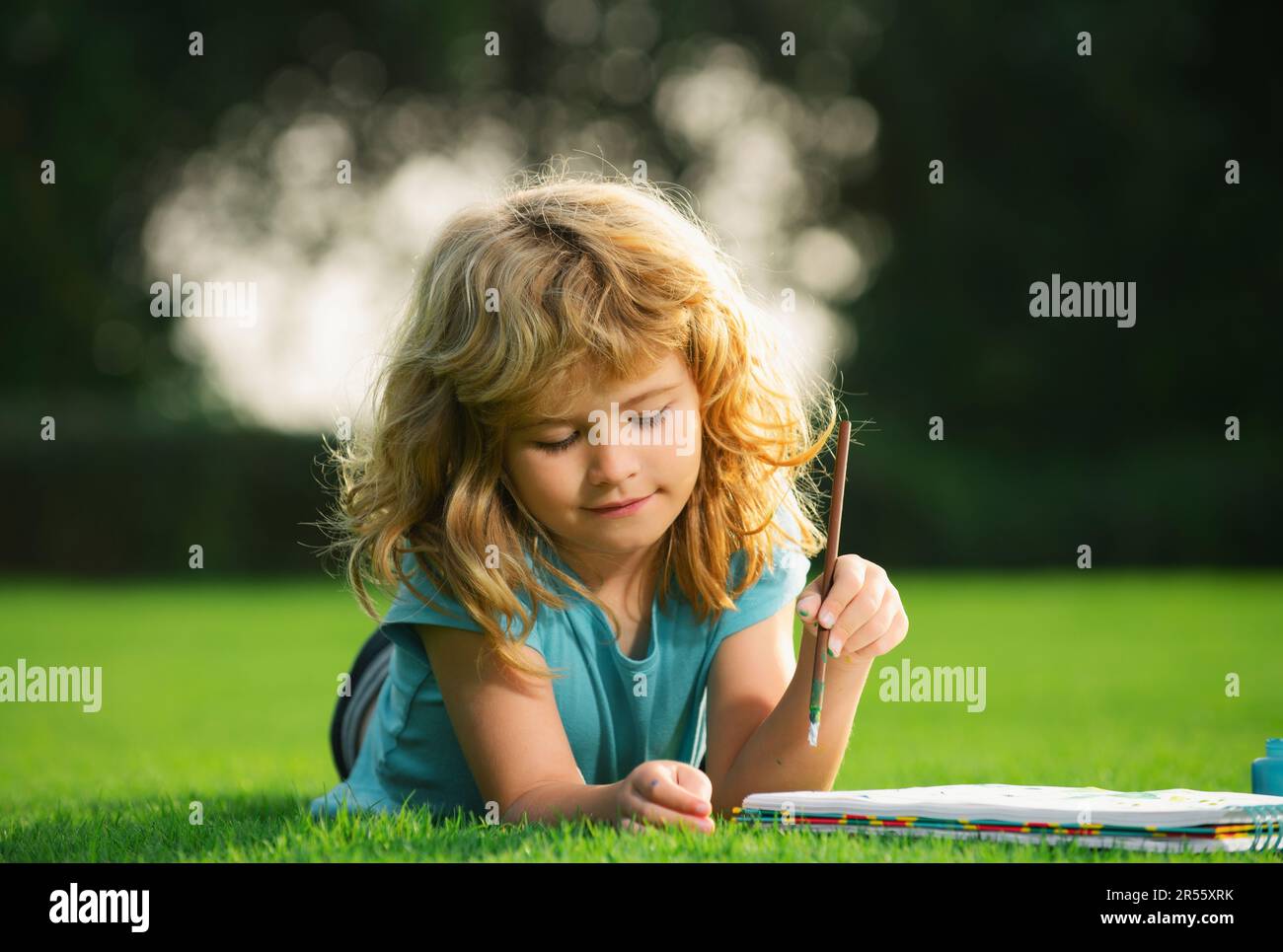 Children draw paint pictures outside, childrens creativity. Portrait of ...