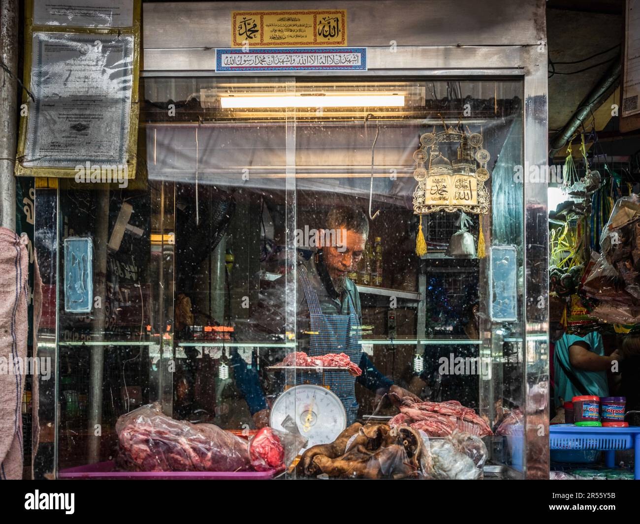 A Thai Muslim butcher is preparing his display of fresh meat Khlong ...