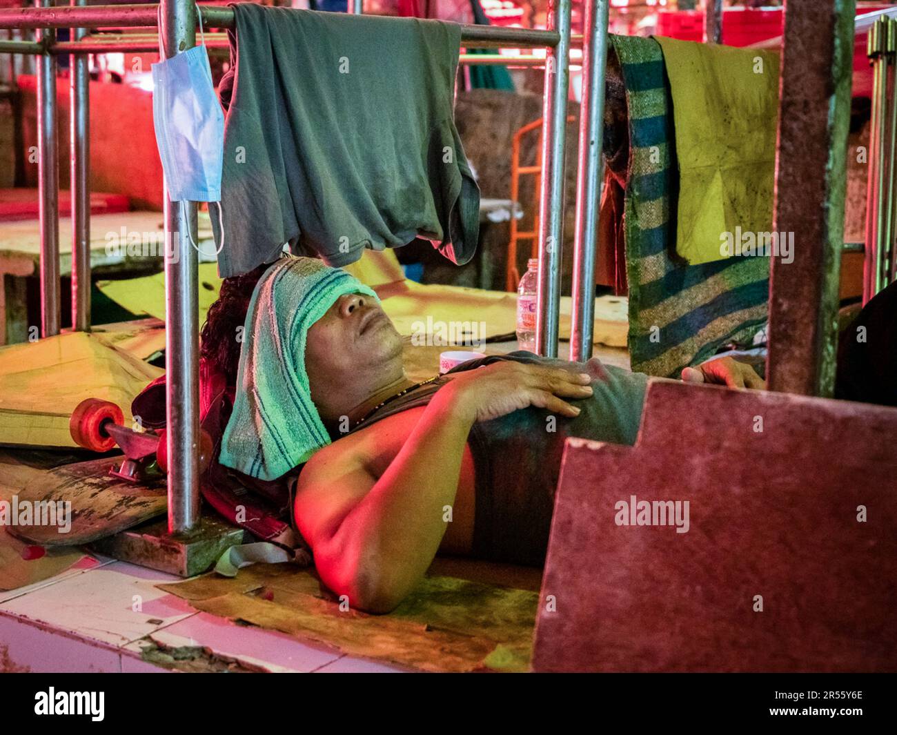 A local vendor seen sleeping on an empty stall at Khlong Toei Market ...