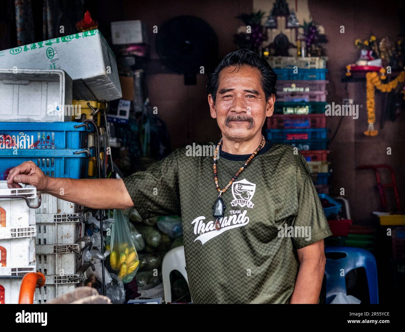 A local Thai seller seen in front of his shop at Khlong Toei Market ...
