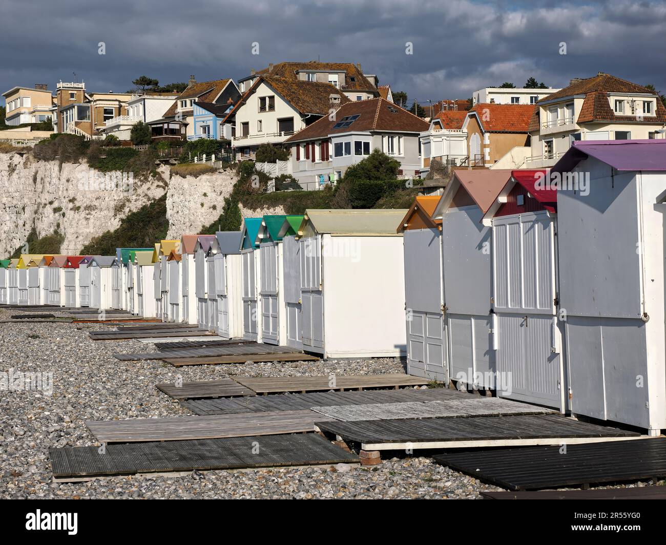 Beach cabins and town at Criel sur Mer, a commune in the Seine-Maritime ...
