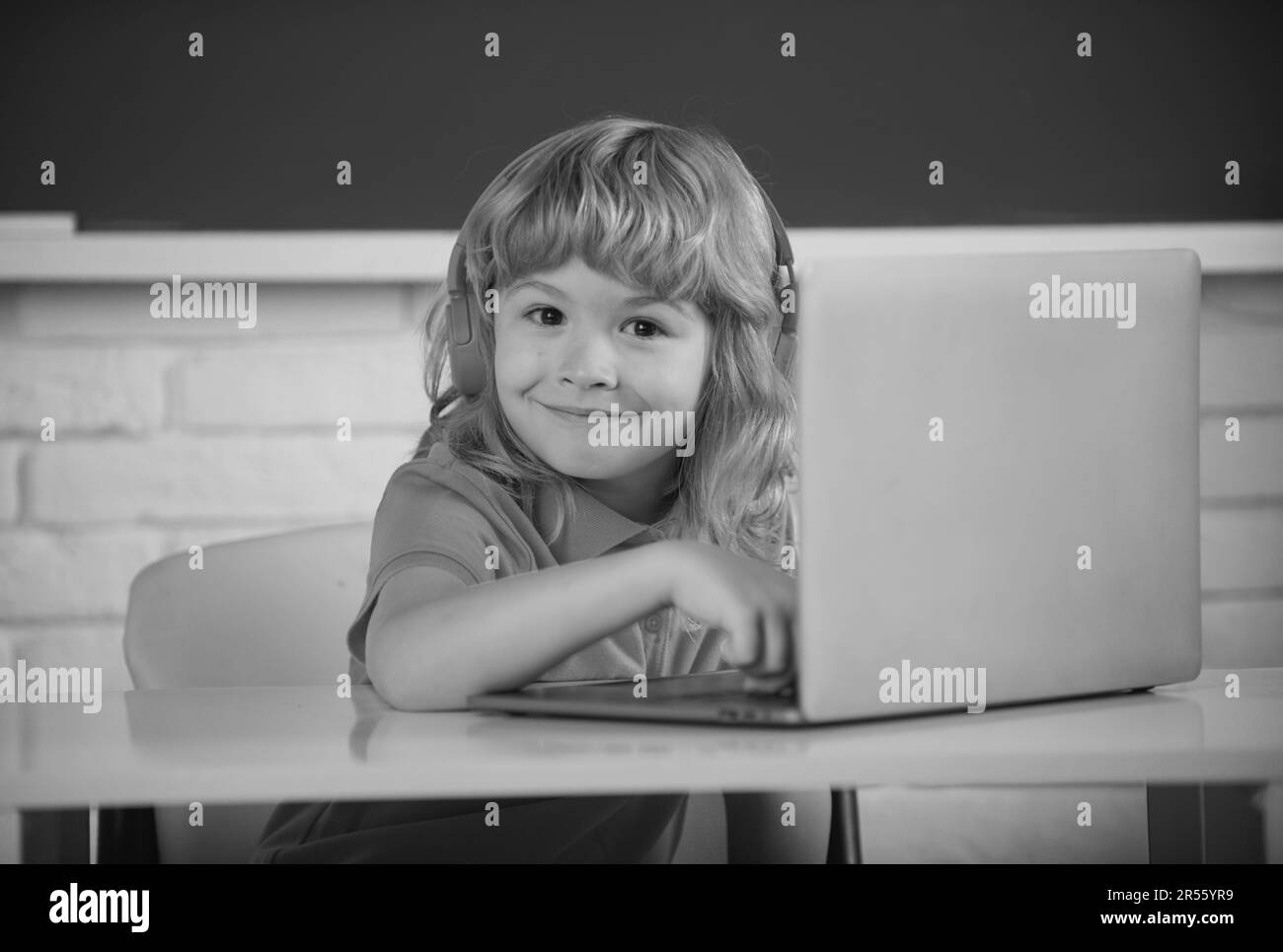 Cute funny child using laptop computer, kid boy studying through online ...