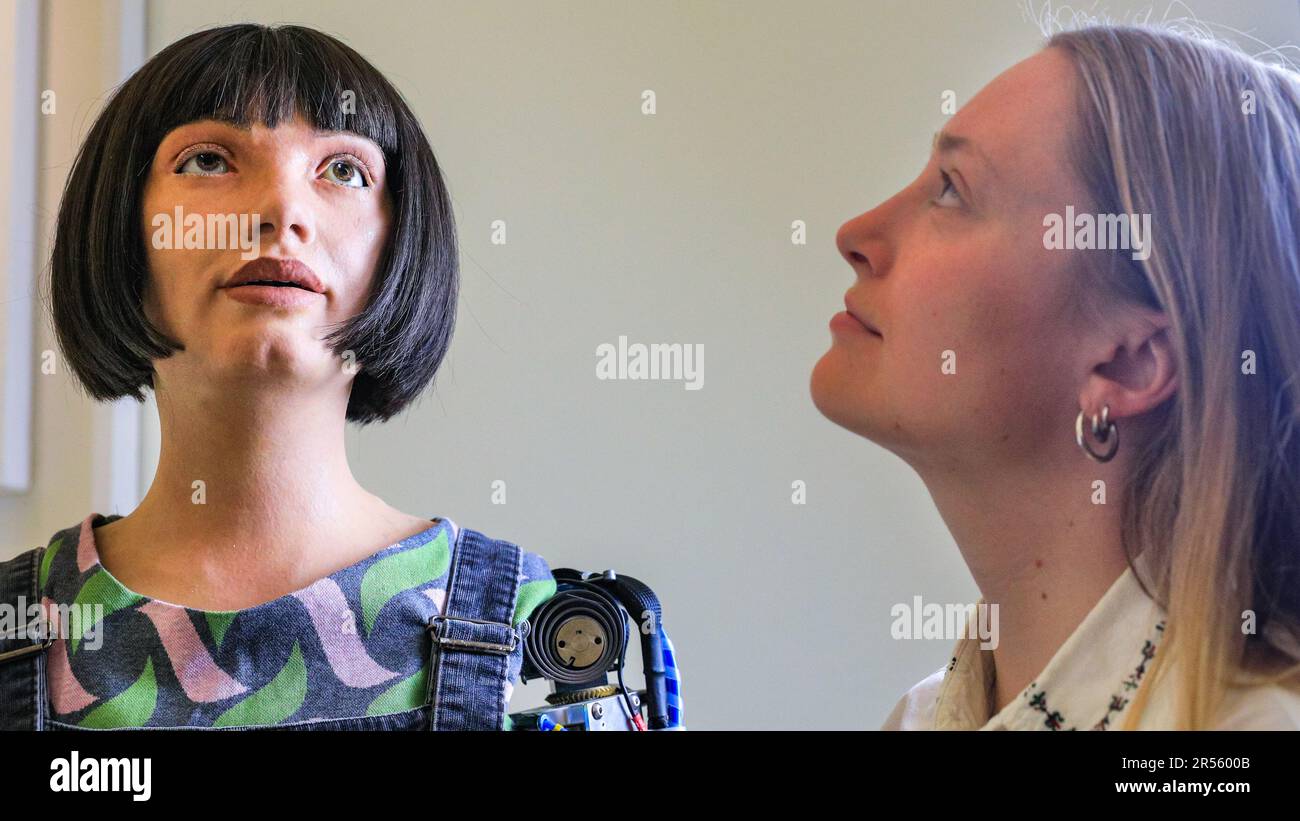 London, UK, 01st June 2023. Exhbition staff with Ai-Da. Ai-Da Robot ...