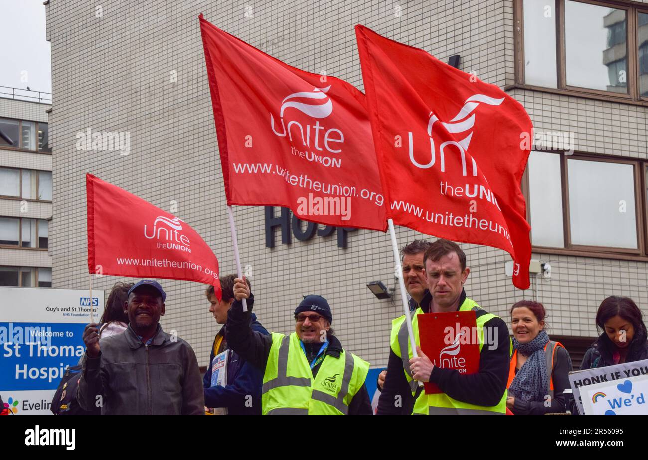 Unite union members hold union flags at the picket line outside St ...