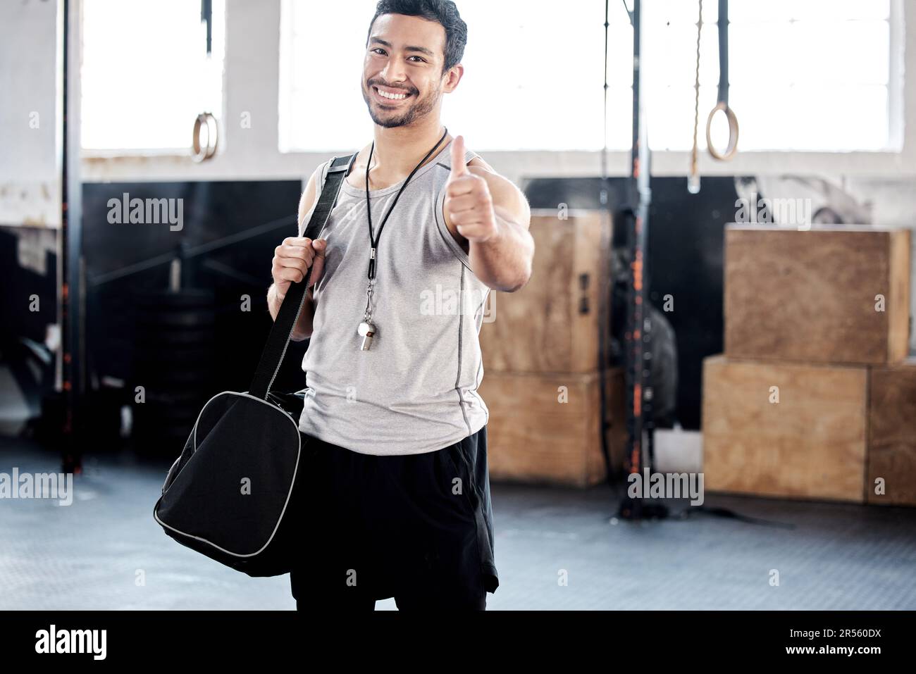 Portrait, thumbs up and happy man in gym with bag for sports goals ...