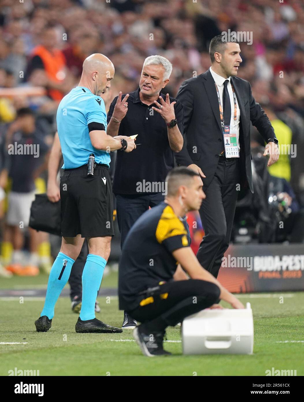 Roma manager Jose Mourinho (right) exchanges words with referee Anthony ...