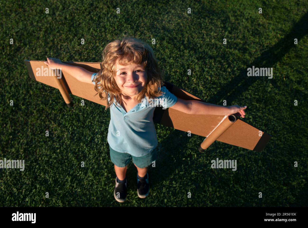 Kid boy dreams and travels. Boy with airplane toy outdoors. Happy child ...