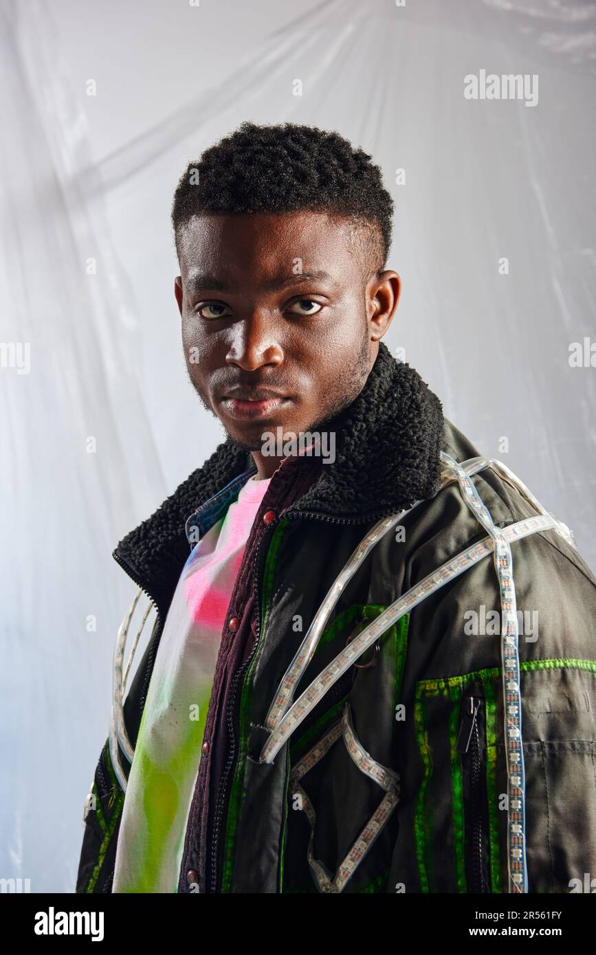 Portrait of young afroamerican model in outwear jacket with led stripes ...