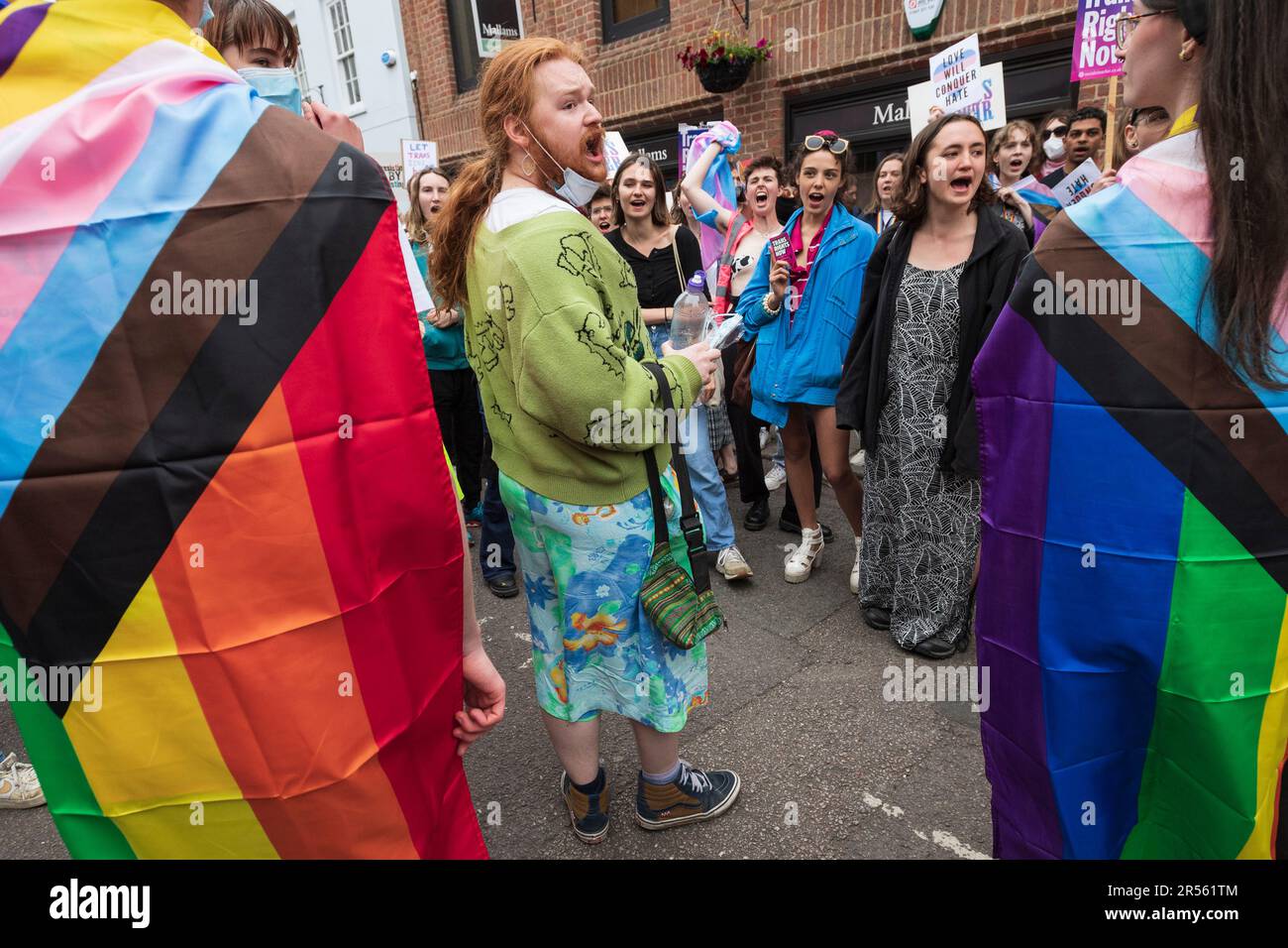 A group of pro-trans rights advocates are peacefully protesting outside ...