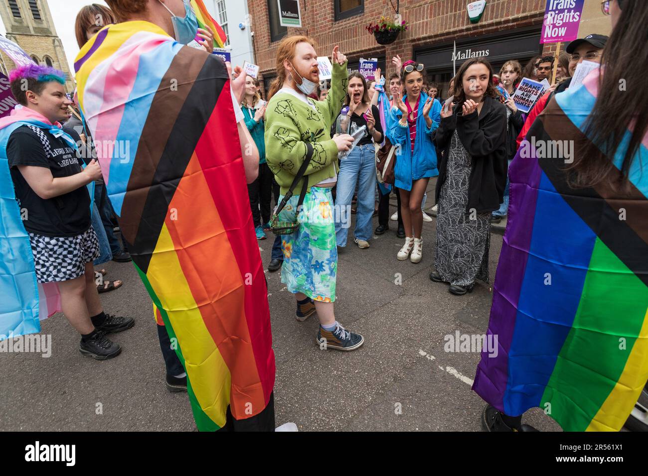 A group of pro-trans rights advocates are peacefully protesting outside ...