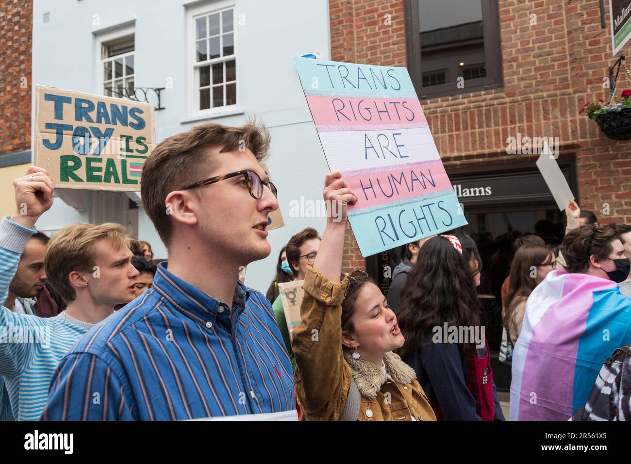 A group of pro-trans rights advocates are peacefully protesting outside ...
