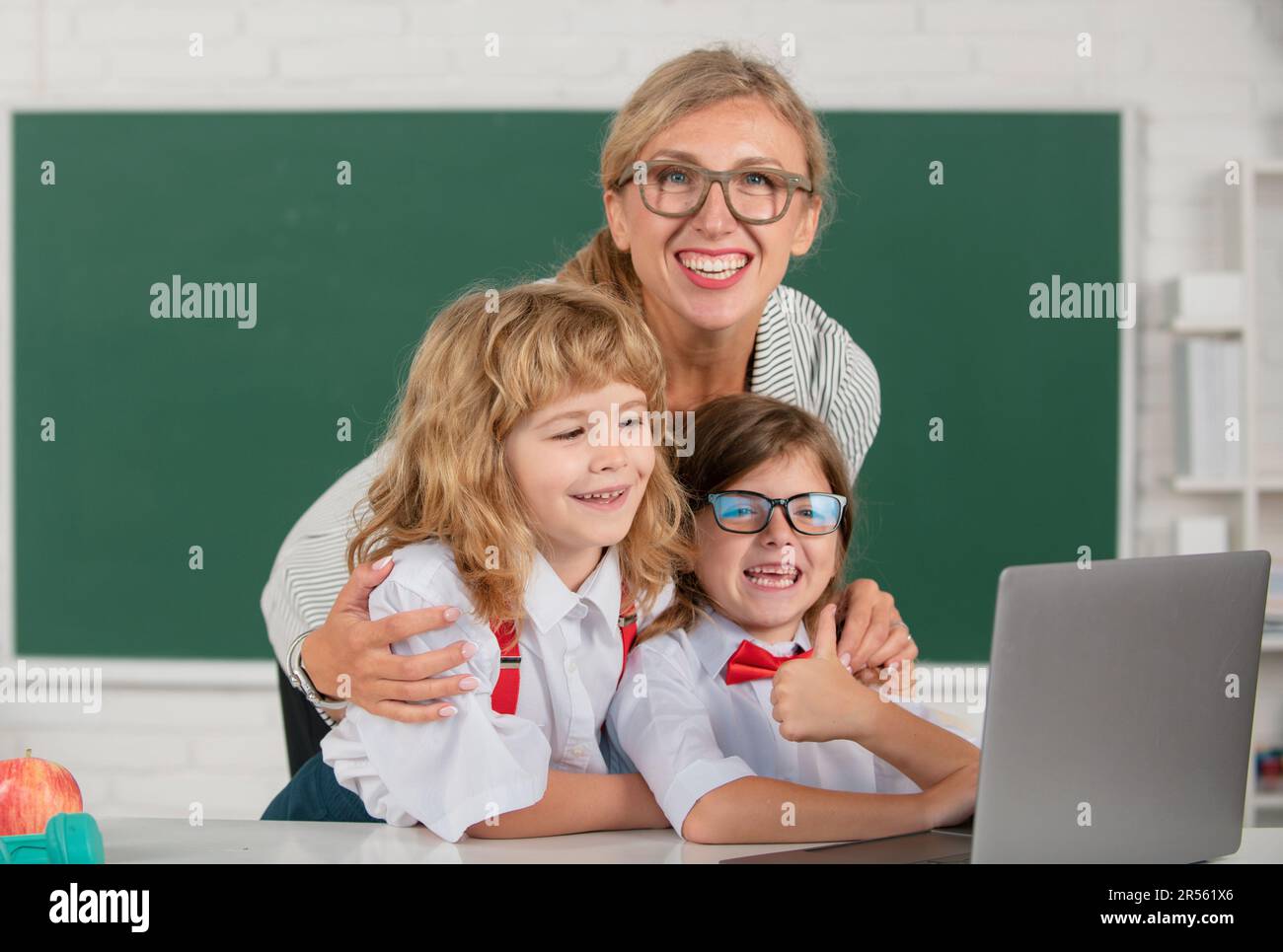Kids learning with teacher. Children from elementary school study at ...