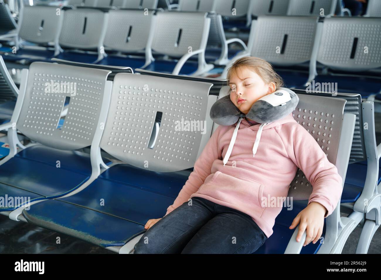 Kid, teen tired girl sleeping, waiting in airport passenger terminal ...