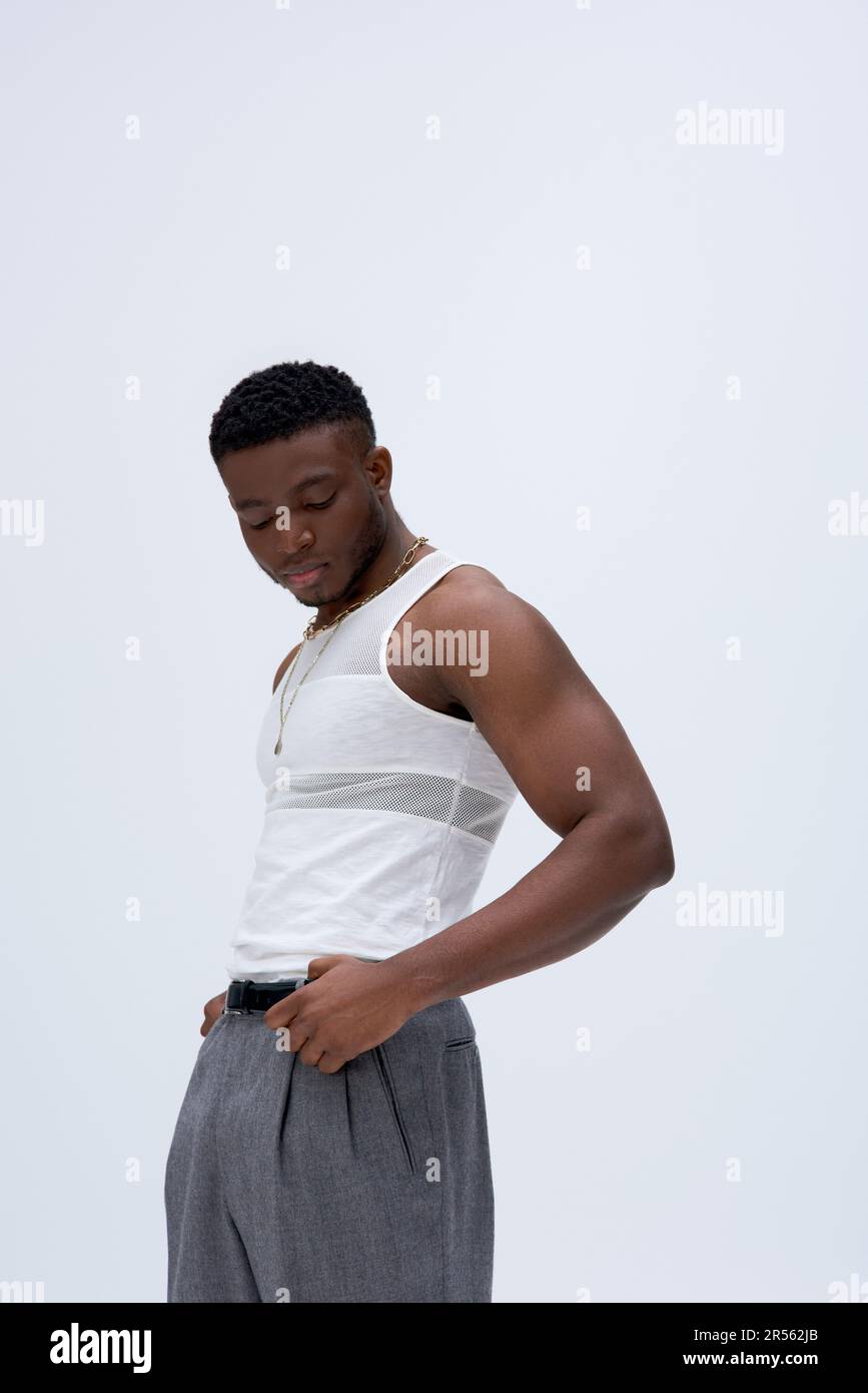 Fashionable and muscular young african american man in tank top and ...