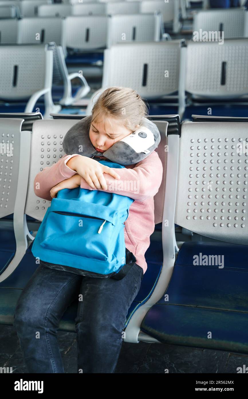 Kid, teen tired girl sleeping, waiting in airport passenger terminal ...