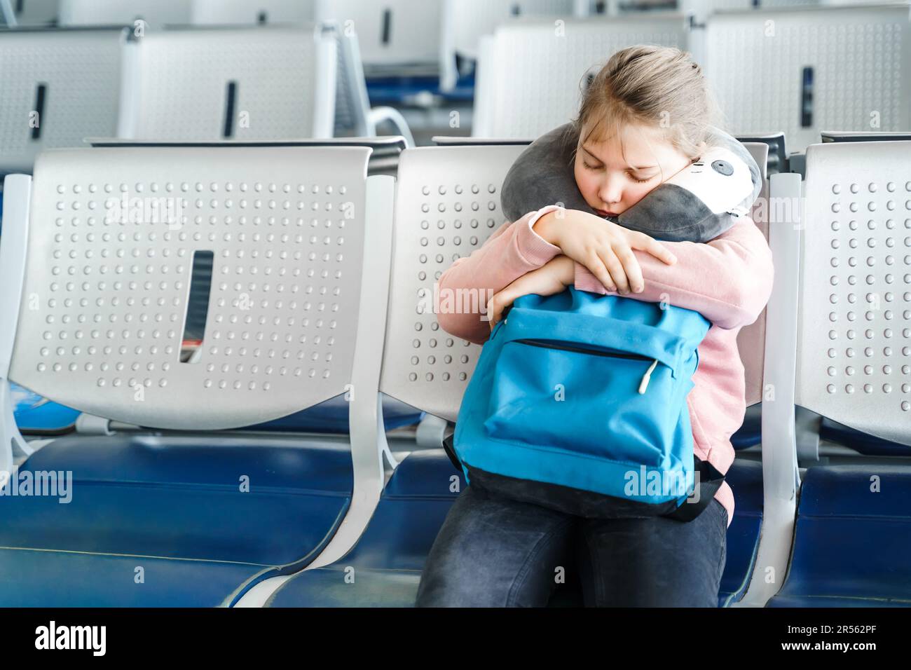 Kid, teen tired girl sleeping, waiting in airport passenger terminal ...