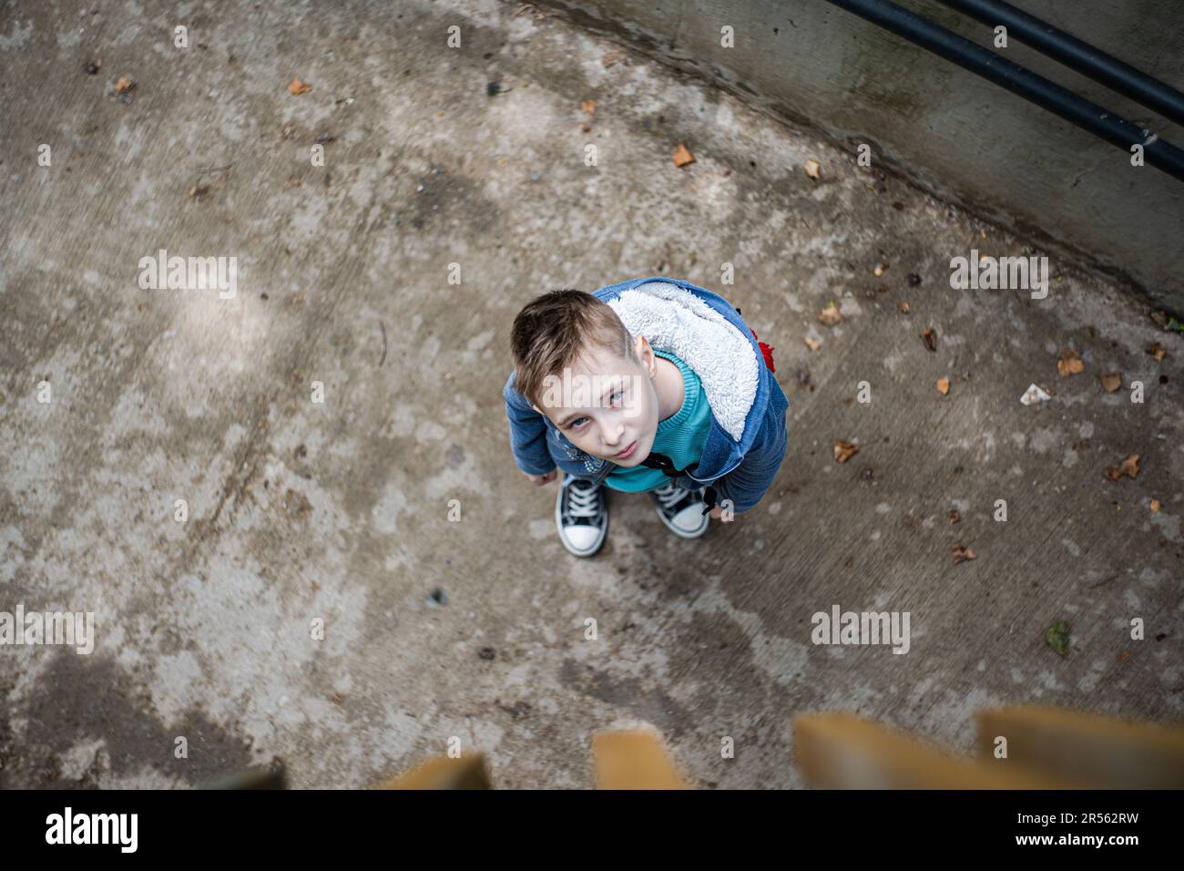 Overhead view of a boy standing in street looking up Stock Photo - Alamy
