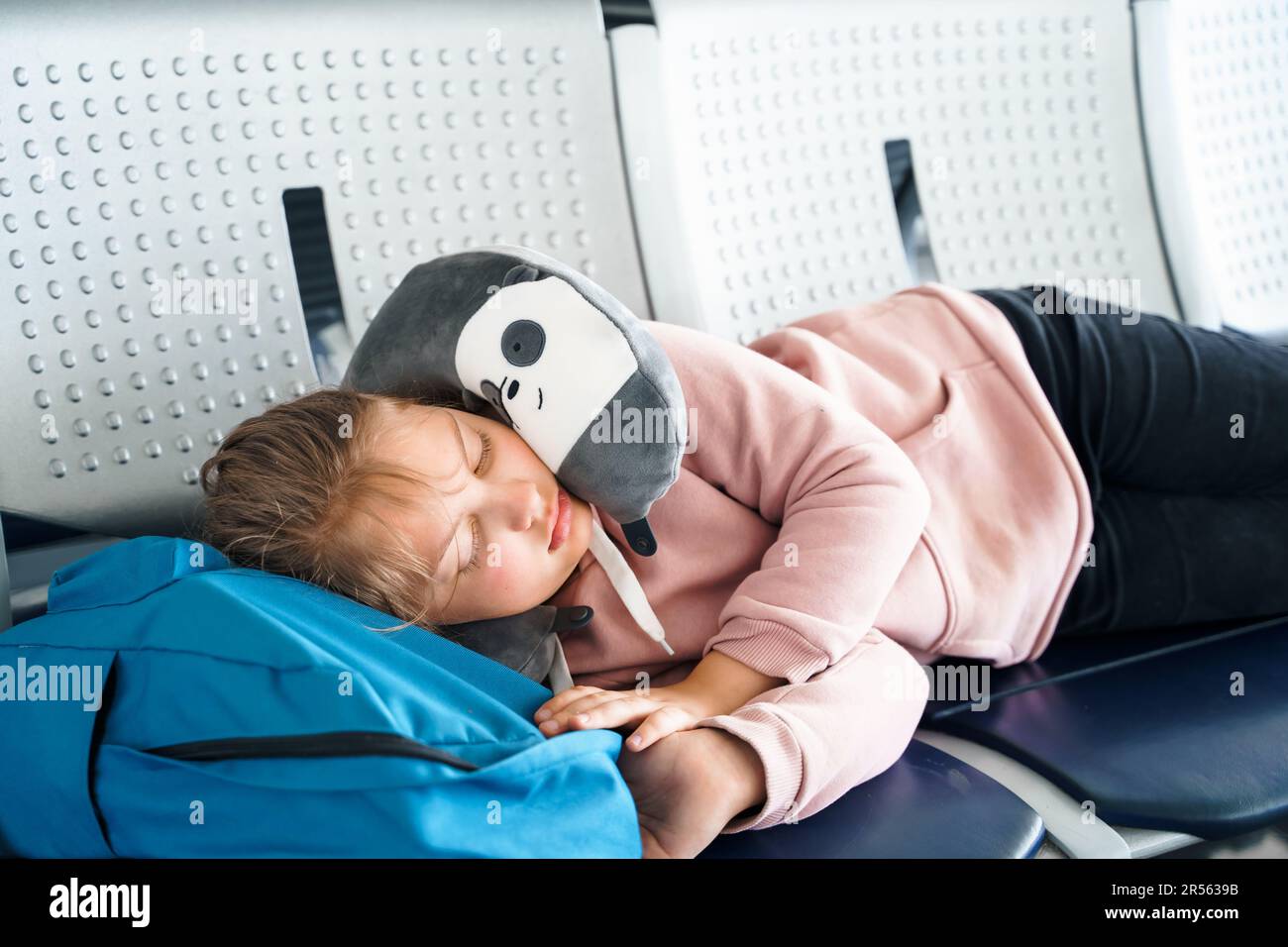 Kid, teen tired girl sleeping, waiting in airport passenger terminal ...